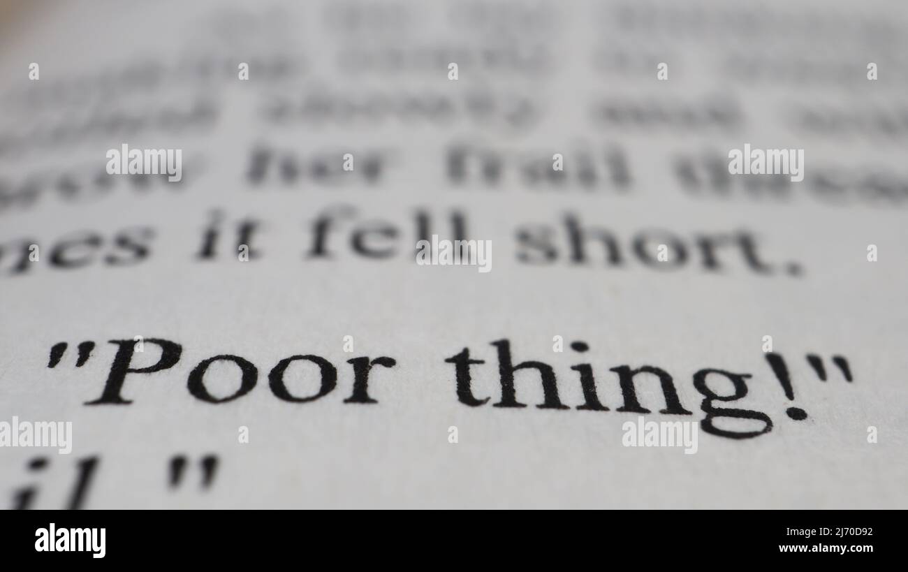 Poor thing text in open book page, selective focus, close up, macro ...