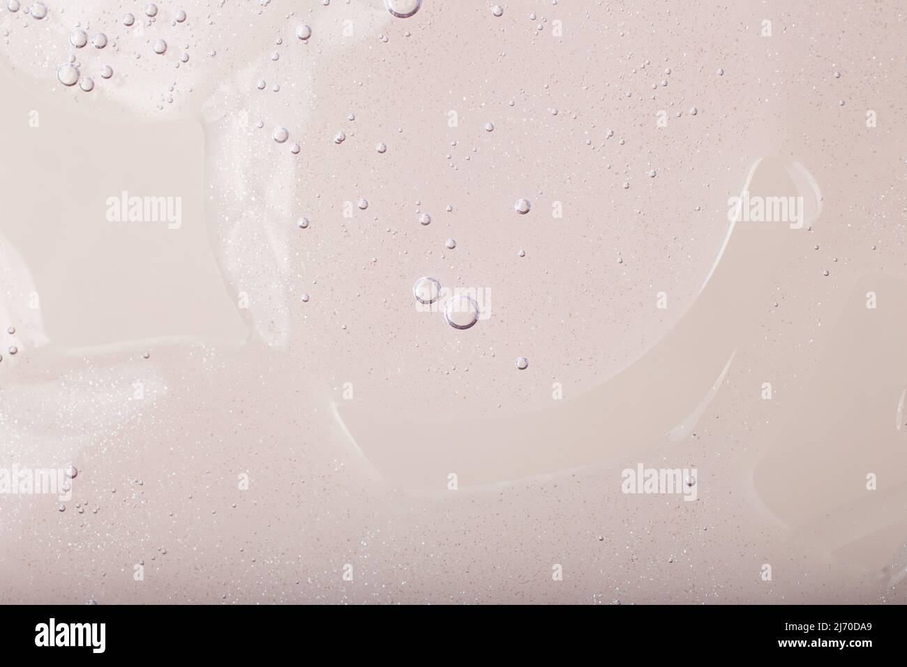 Top view of liquid cosmetics gel with bubbly structure on pastel ...