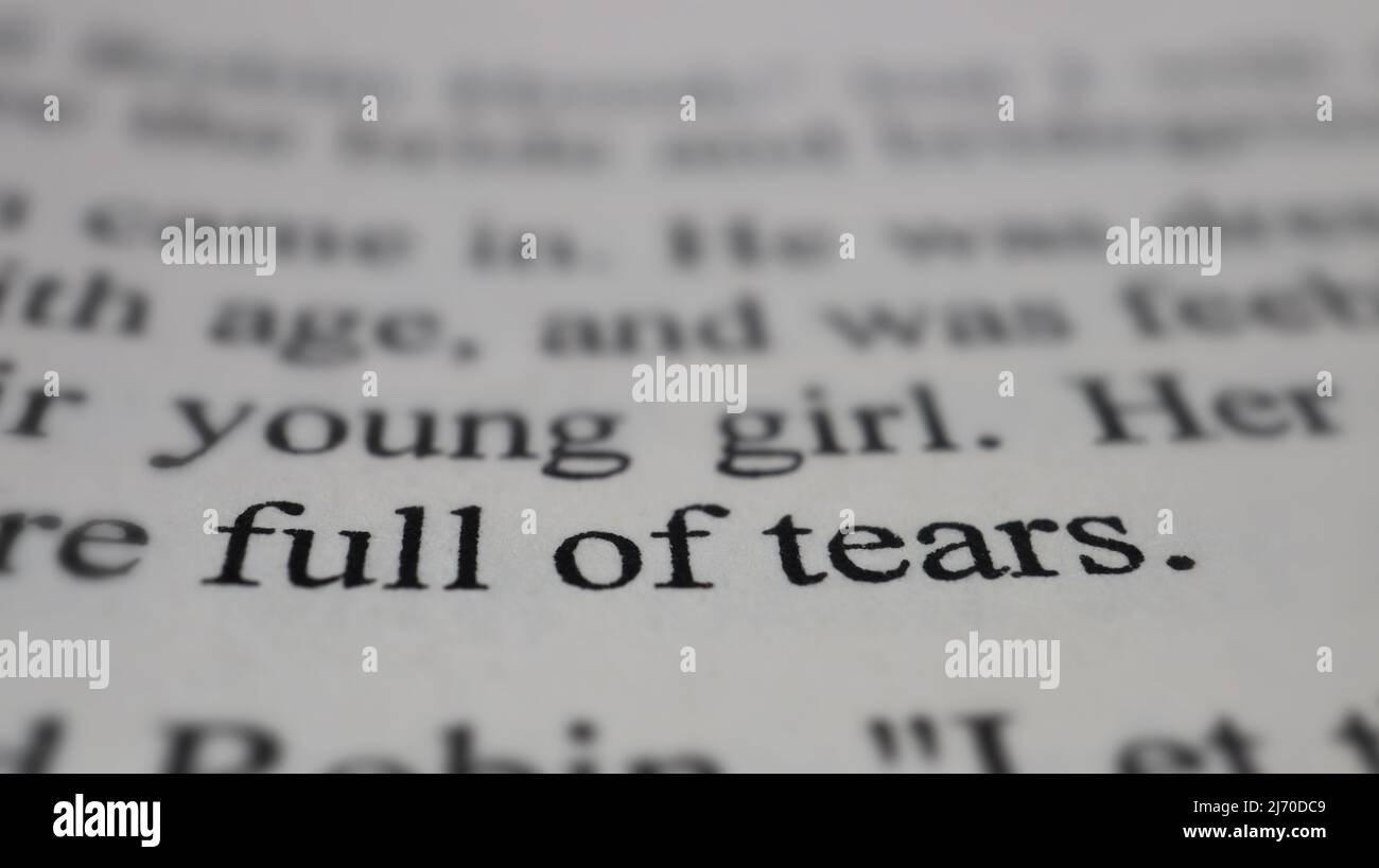 Full of tears text in open book page, selective focus, close up, macro ...