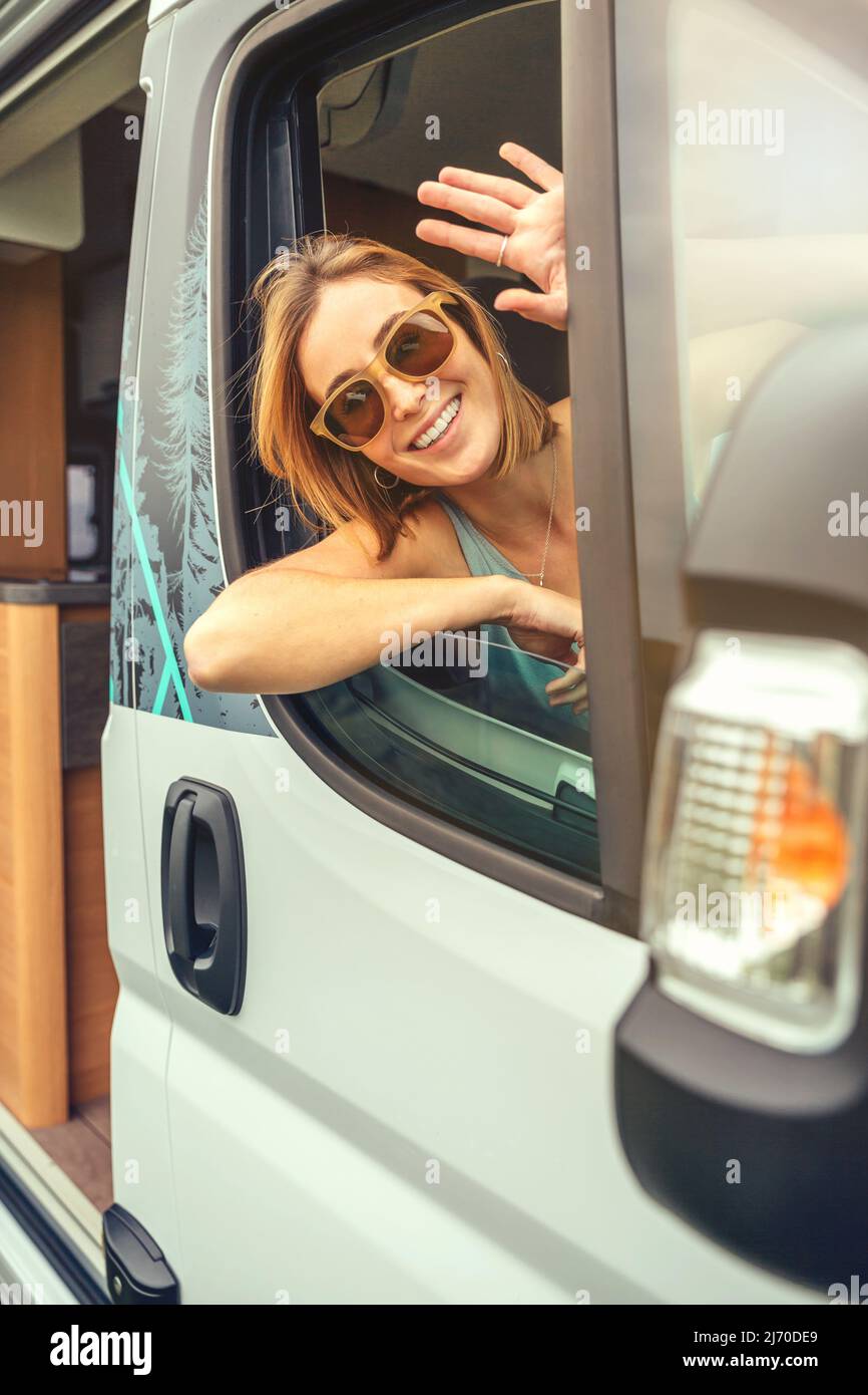 Young woman in sunglasses sitting in camper van Stock Photo - Alamy