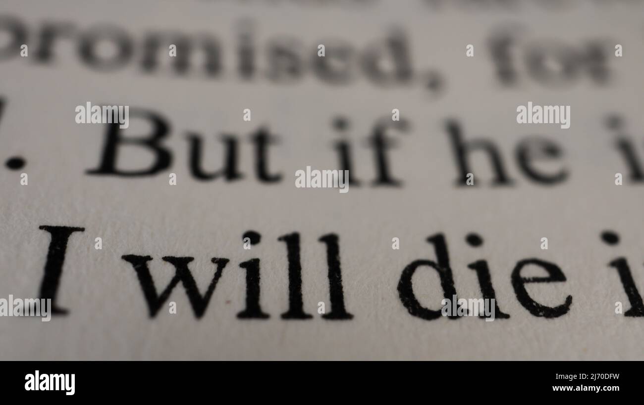 I will die text in open book page, selective focus, close up, macro ...
