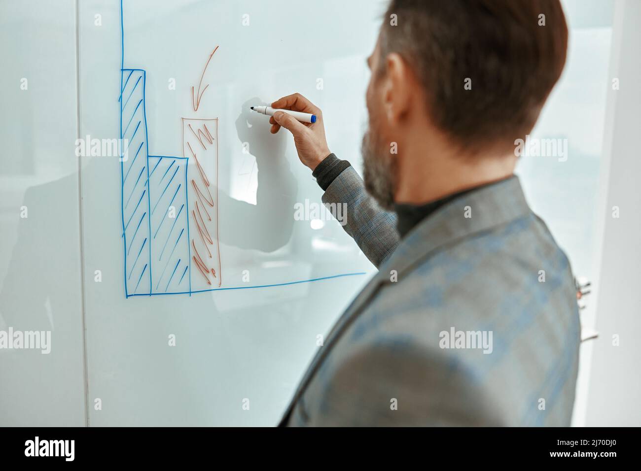 Businessman writing on whiteboard marker hi-res stock photography and ...