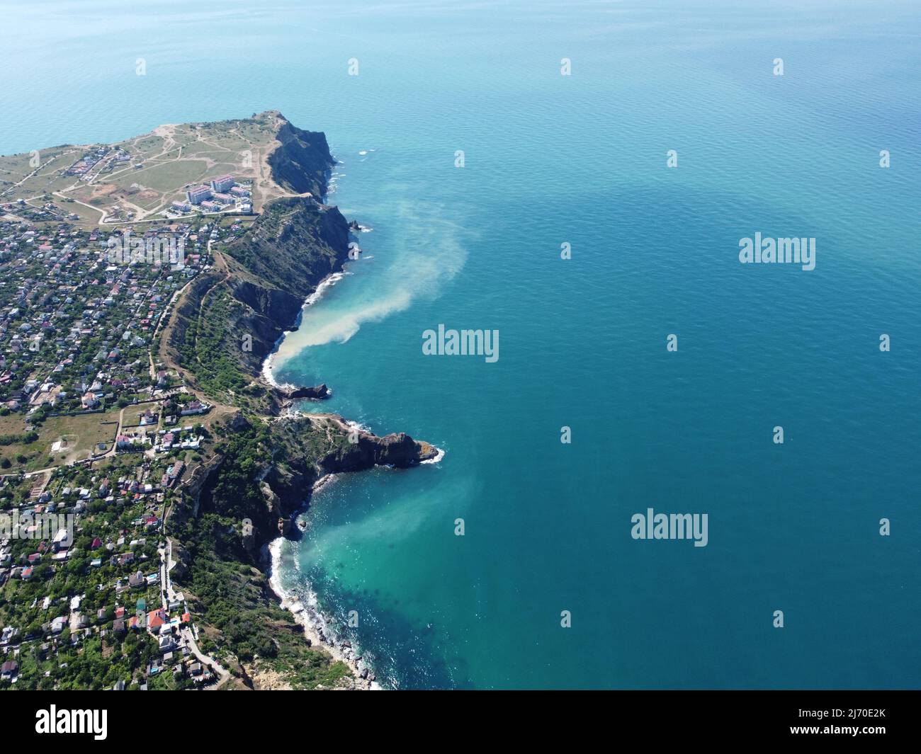 Aerial view from above on calm azure sea and volcanic rocky shores ...