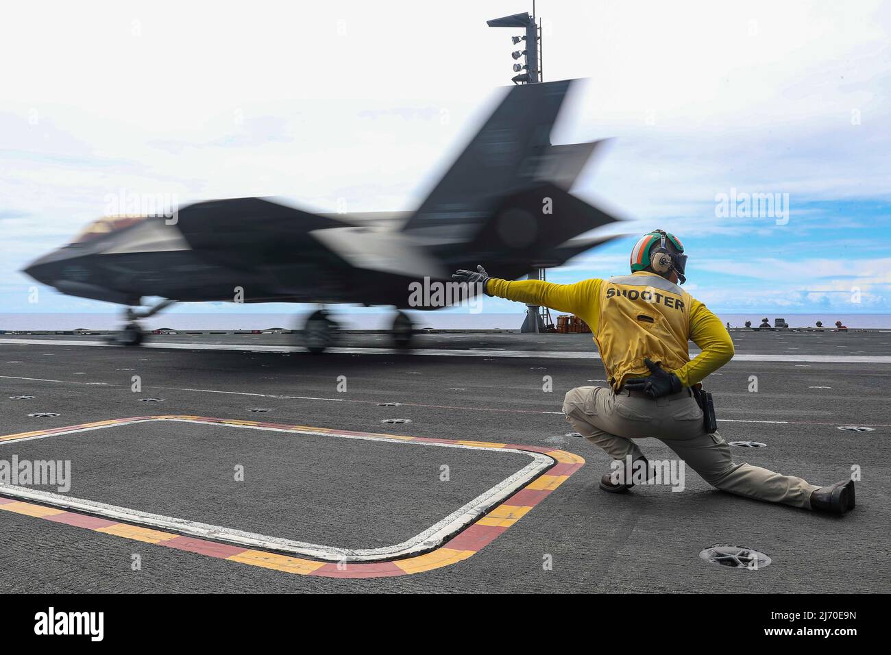 PHILIPPINE SEA (May 3, 2022) Lt. Ji Hong, from Allen, Texas, signals an ...