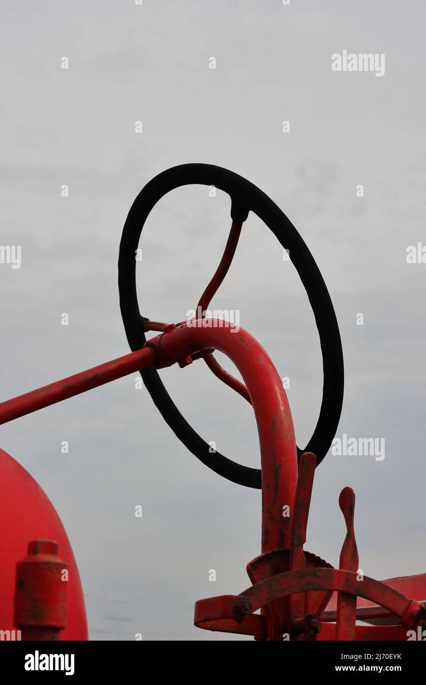 Traditional vintage bright red tractor mechanical engine and frame ...