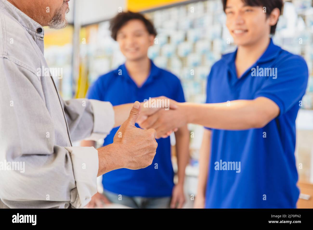 Customer thumb up and shake hand with sale person satisfied in service ...