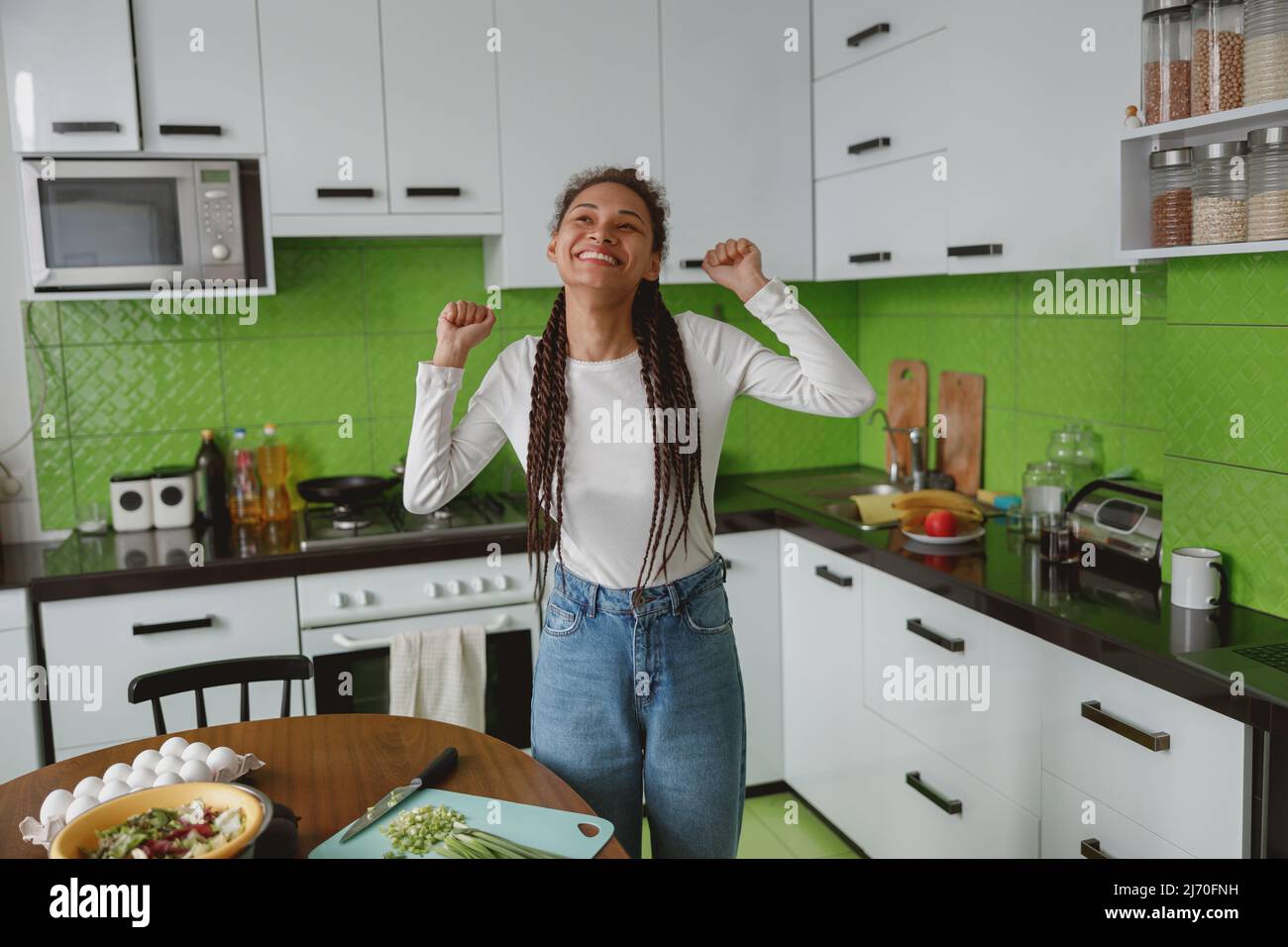 Young smiling woman dancing kitchen hi-res stock photography and images ...