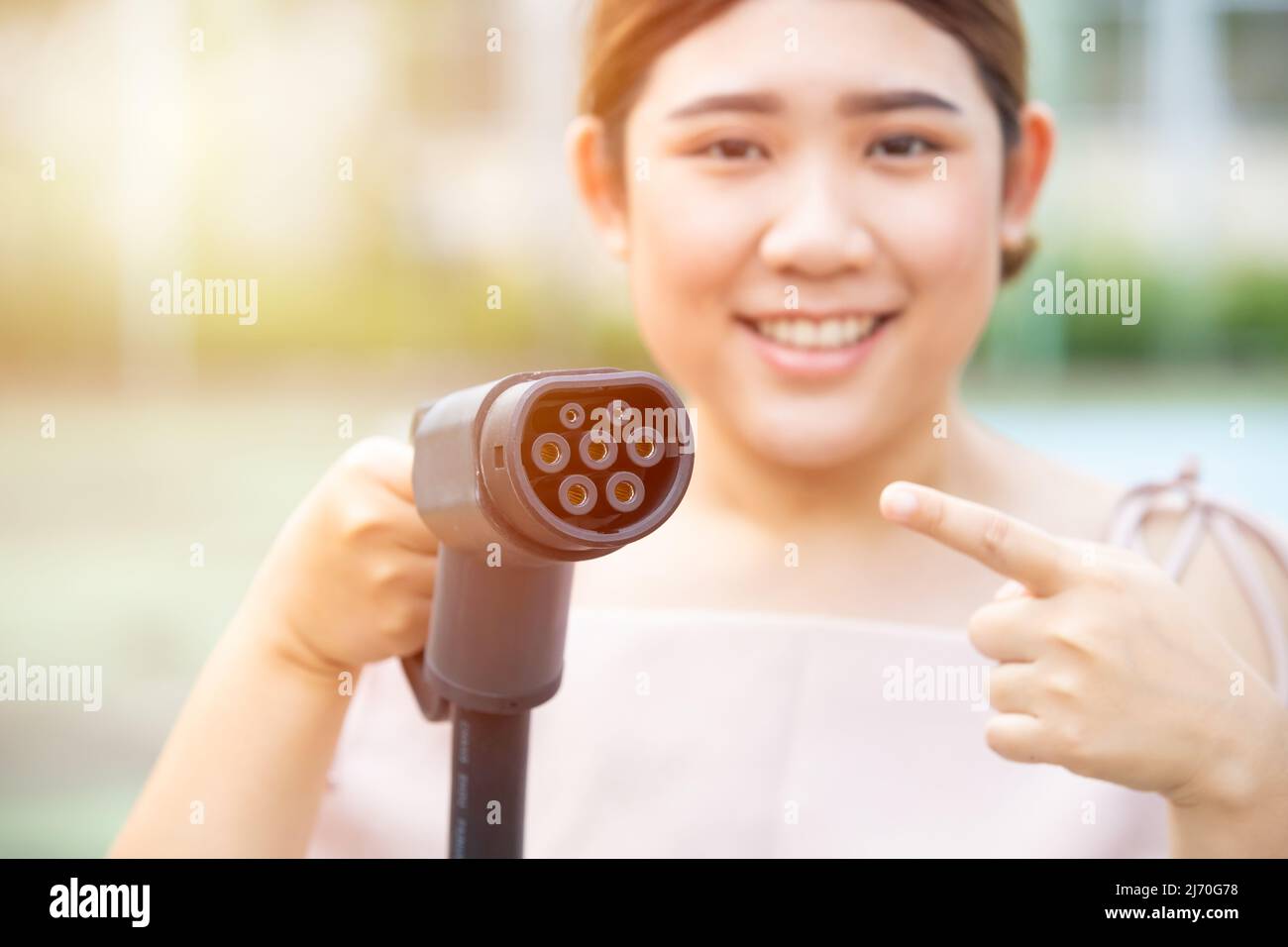 EU Type 2 EV car charger plug with happy smiling women for easy to ...