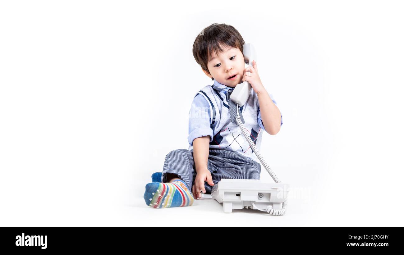 little boy play with phone on white background Stock Photo - Alamy