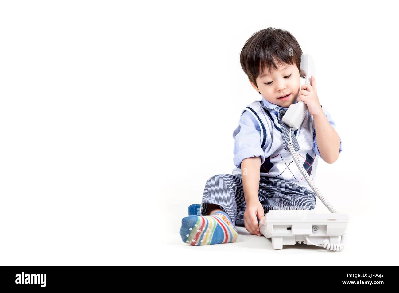 little boy play with phone on white background Stock Photo - Alamy