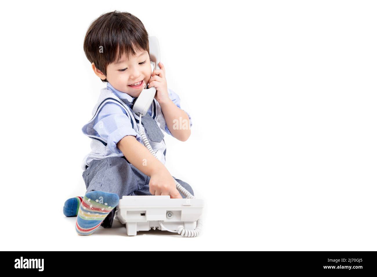 little boy play with phone on white background Stock Photo - Alamy