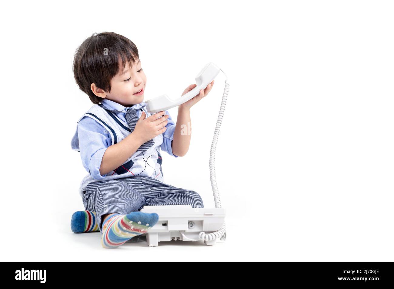 little boy play with phone on white background Stock Photo - Alamy