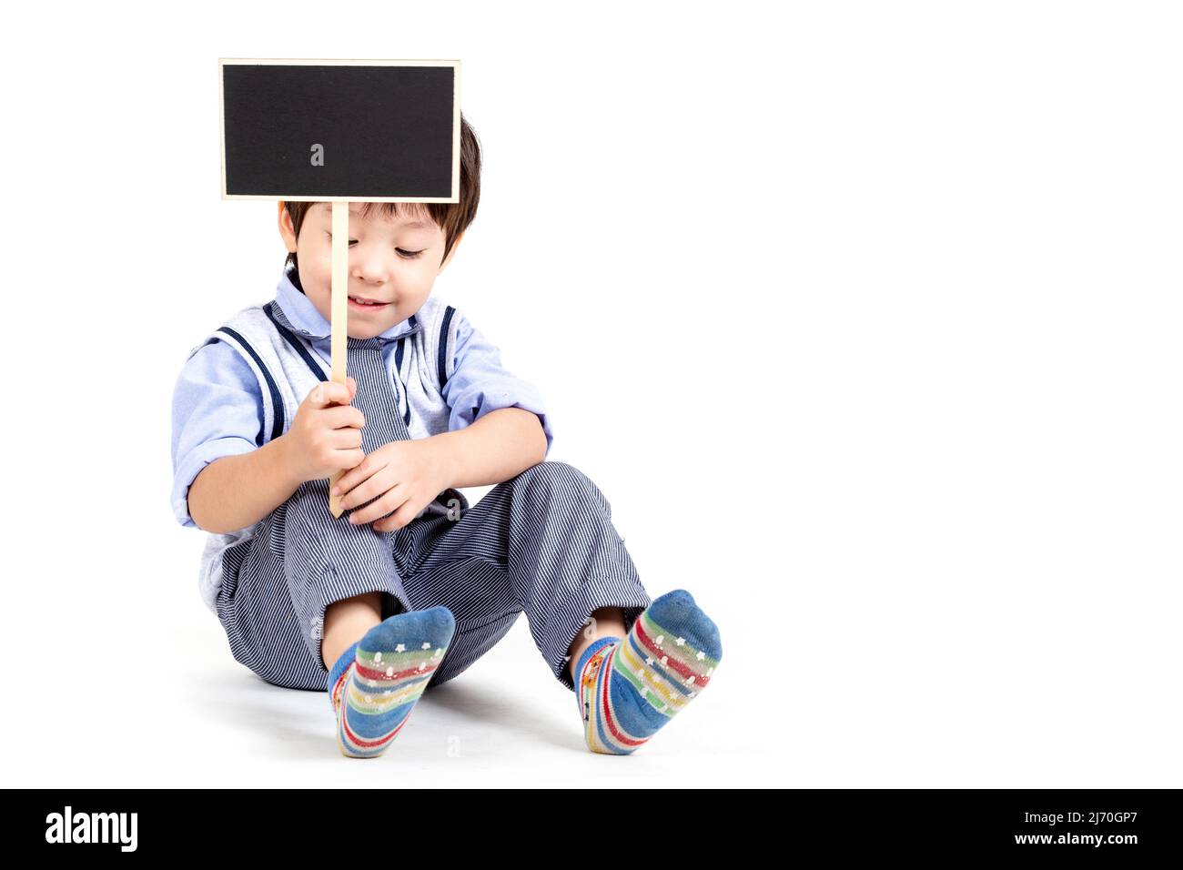 little boy holding a sign on white background Stock Photo - Alamy