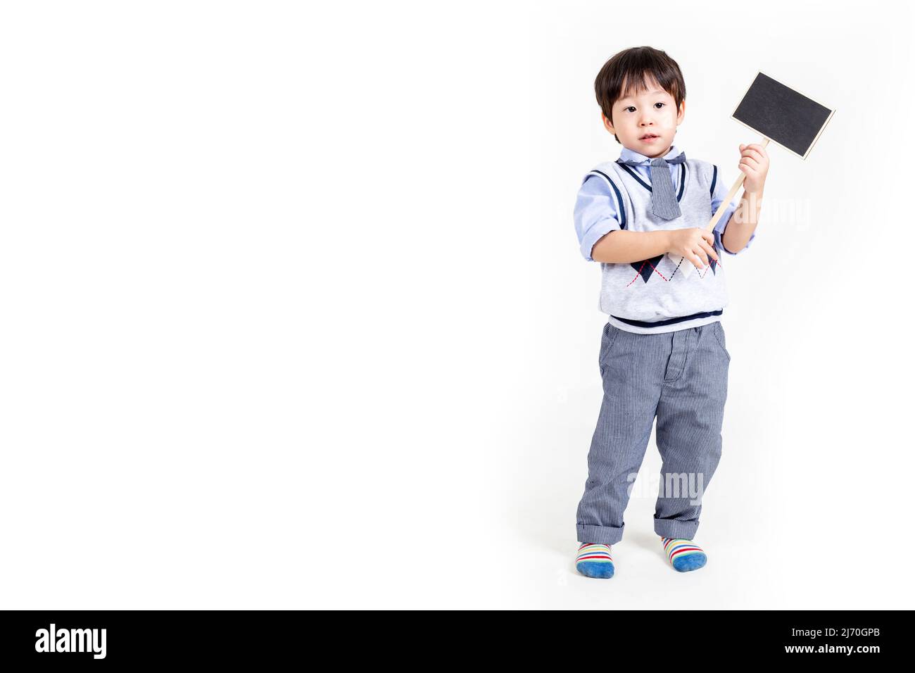 little boy holding a sign on white background Stock Photo - Alamy