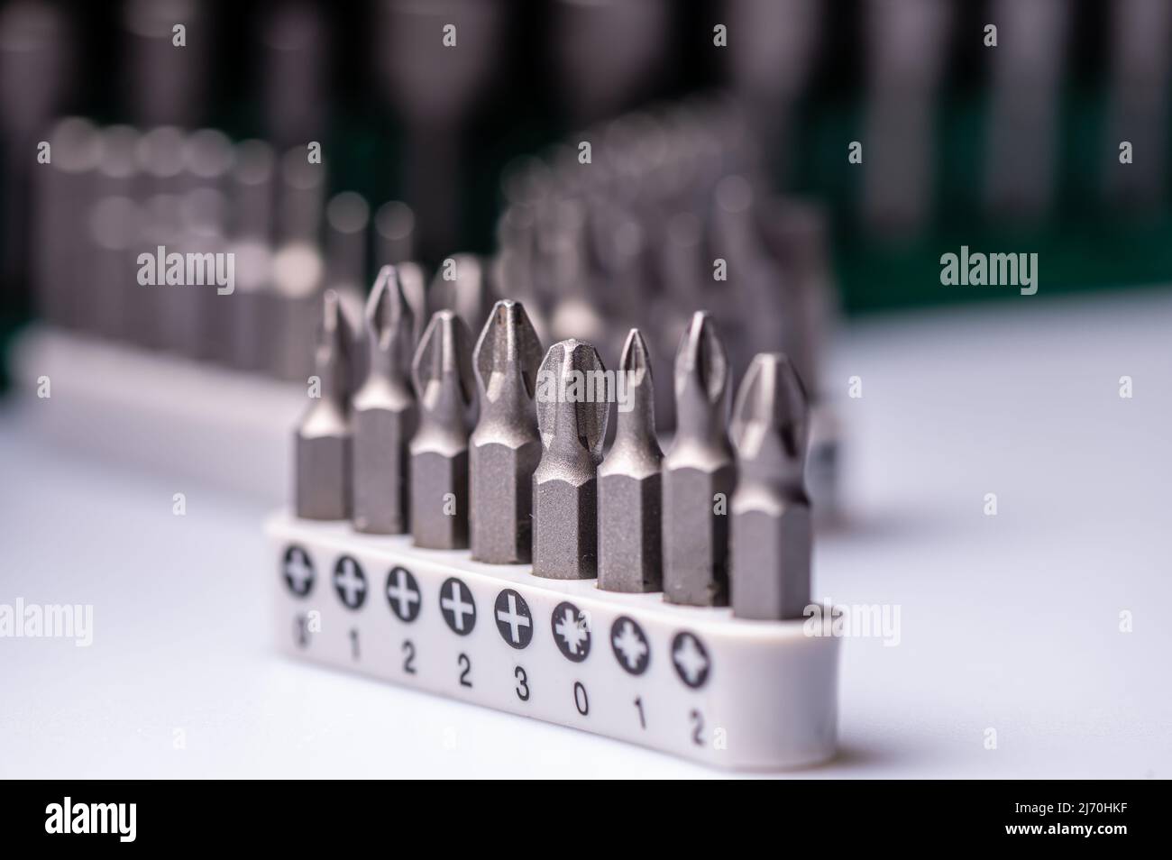 Interchangeable screwdriver bit set, isolated on white, selective focus ...