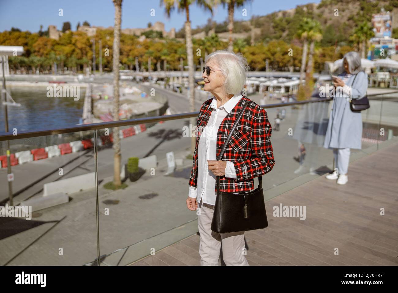Cute older lady walking in day time outdoors Stock Photo - Alamy
