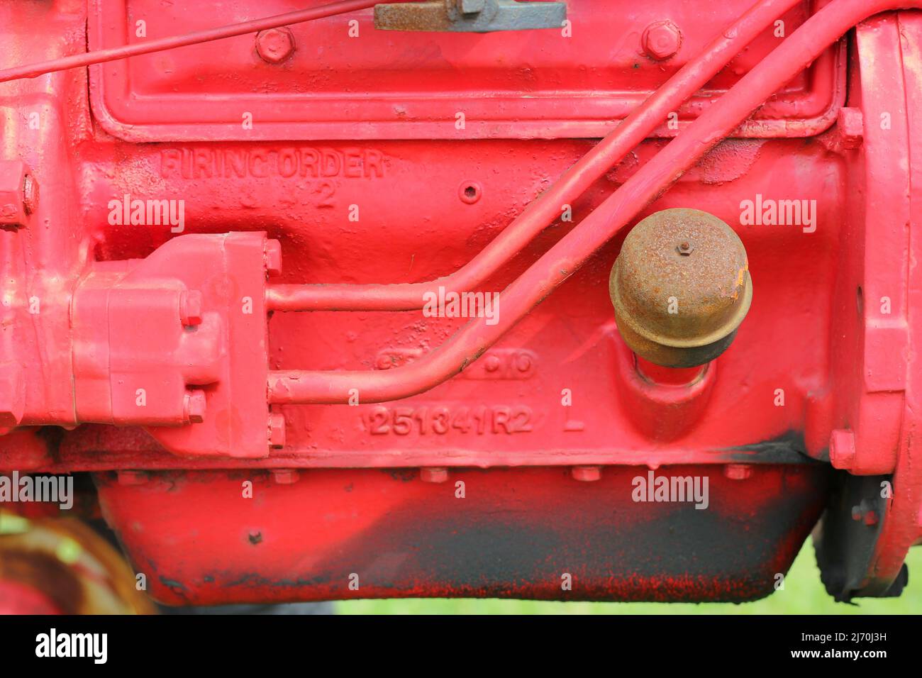 Traditional vintage bright red tractor mechanical engine and frame ...