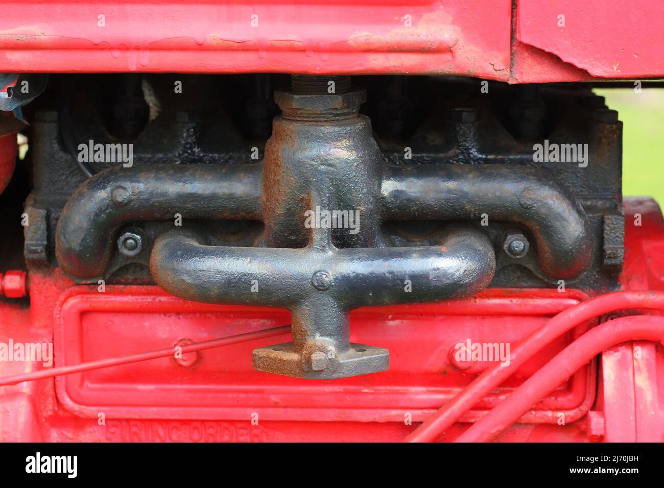 Traditional vintage bright red tractor mechanical engine and frame ...