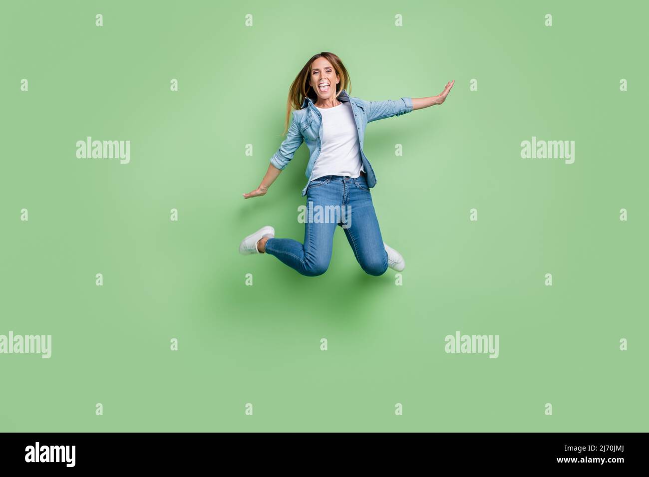 Full body photo of young lady jump wear shirt jeans footwear isolated ...