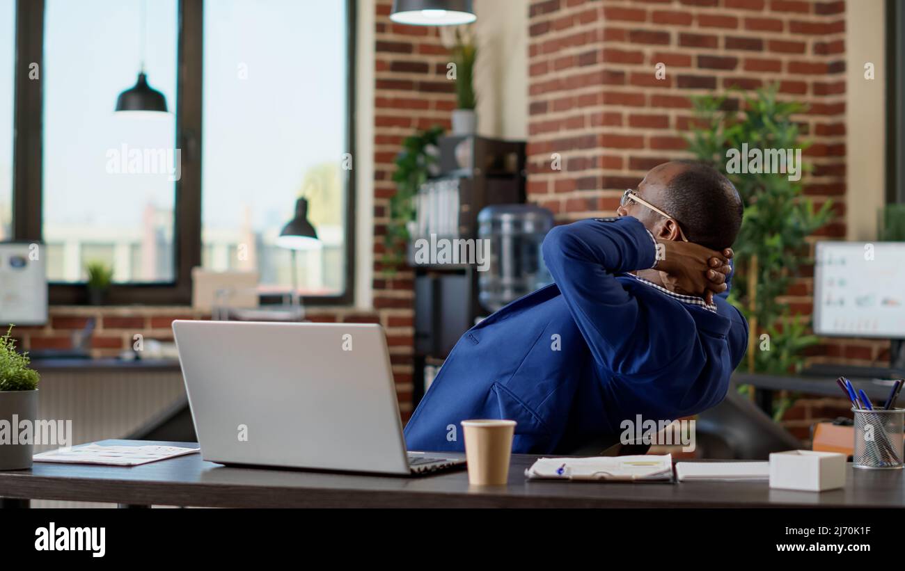 Project manager taking break from online company work on laptop ...