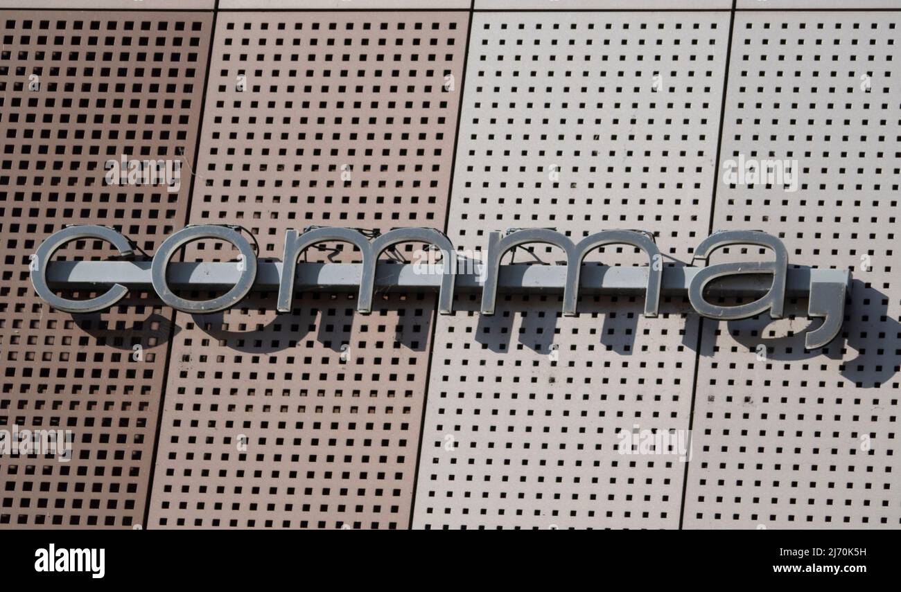 Comma, logo on the facade of the Stadtgalerie mall Stock Photo - Alamy