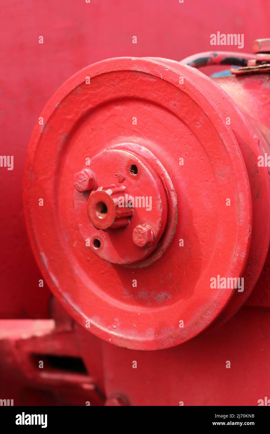 Traditional vintage bright red tractor mechanical engine and frame ...