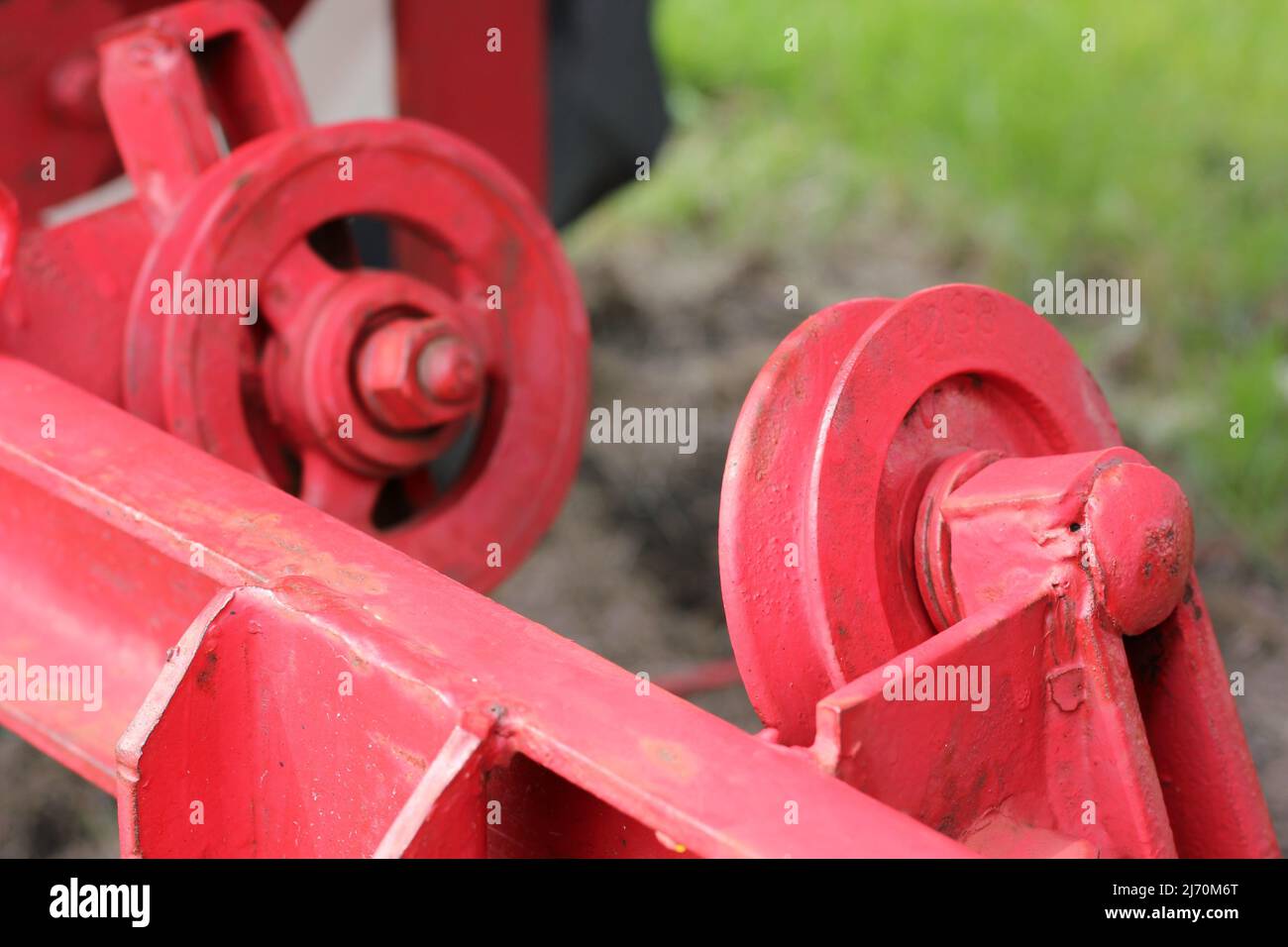 Traditional vintage bright red tractor mechanical engine and frame ...