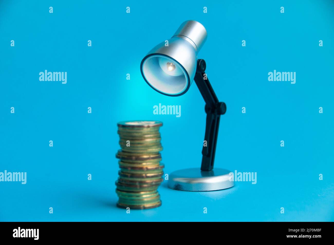 Closeup of gold coins with silver and black small lamp background. Copy ...