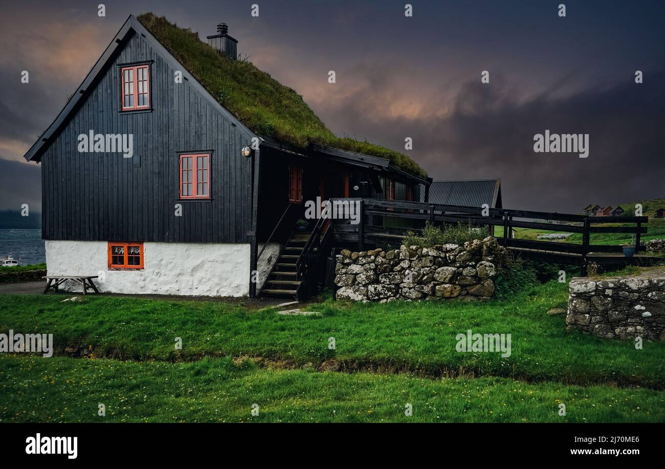 Nice cloudy sunset on Traditional turf house in Village of Kirkjubour ...