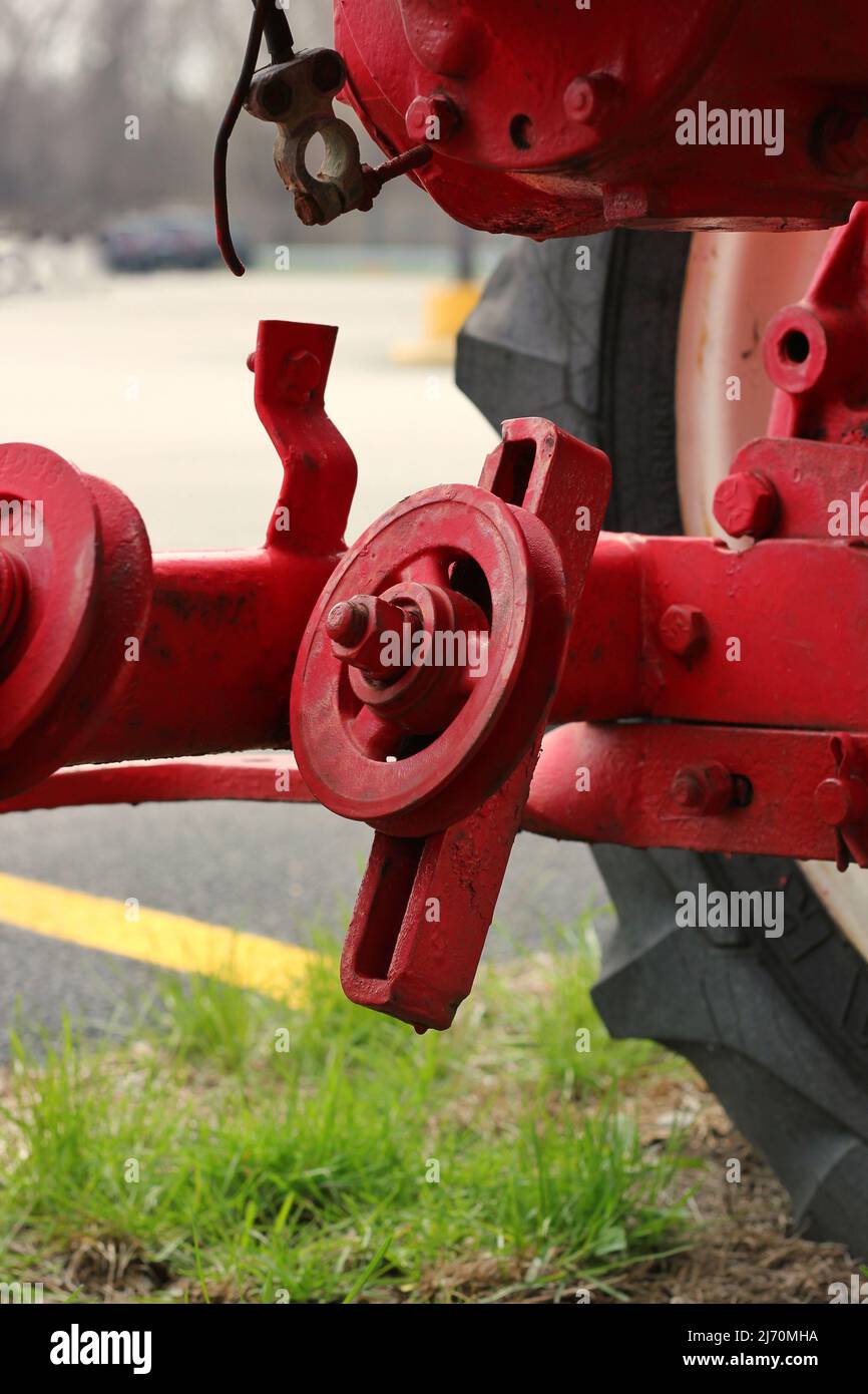 Traditional vintage bright red tractor mechanical engine and frame ...