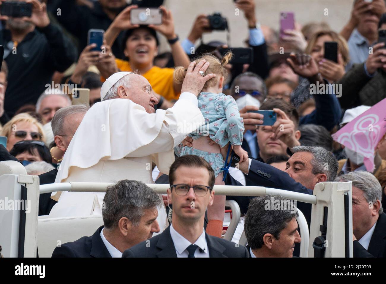 Pope Francis blesses a baby as he arrives in St. Peter's Square. Pope ...