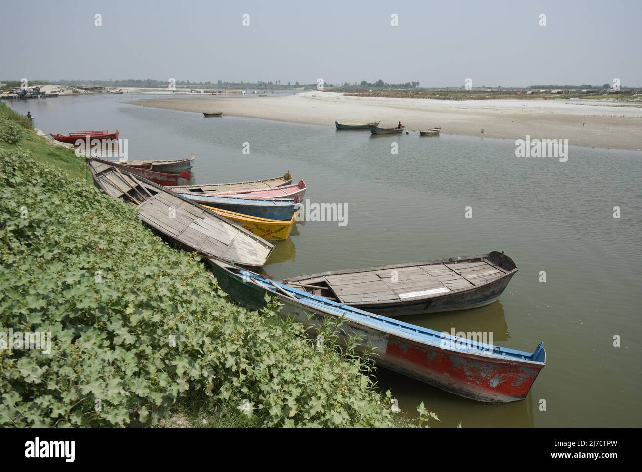 The Ganges with floating boats near Guptar Ghat or Narayan Ghat. Civil ...