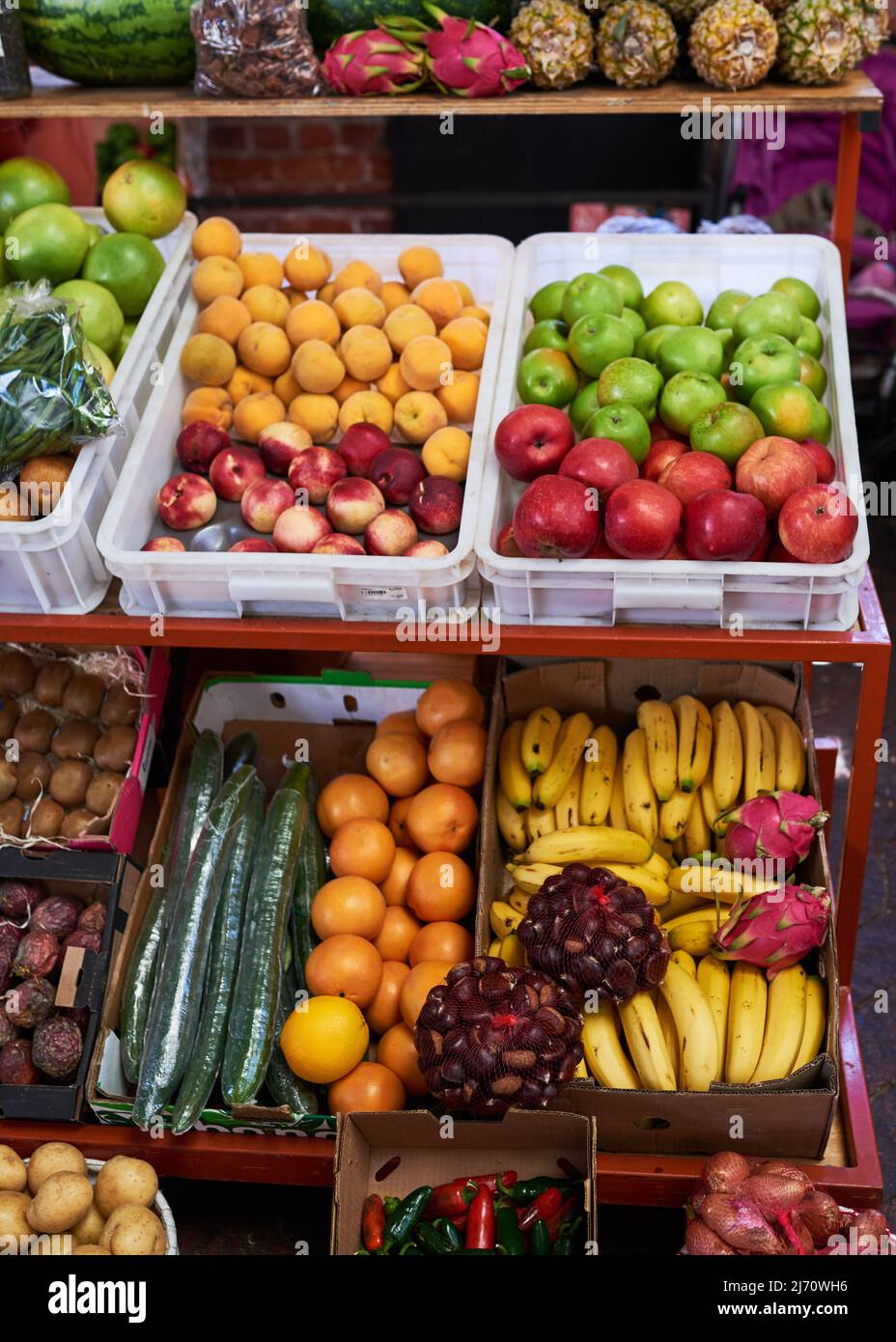 A close up of colourful fruit and vegetable stall at a local market ...