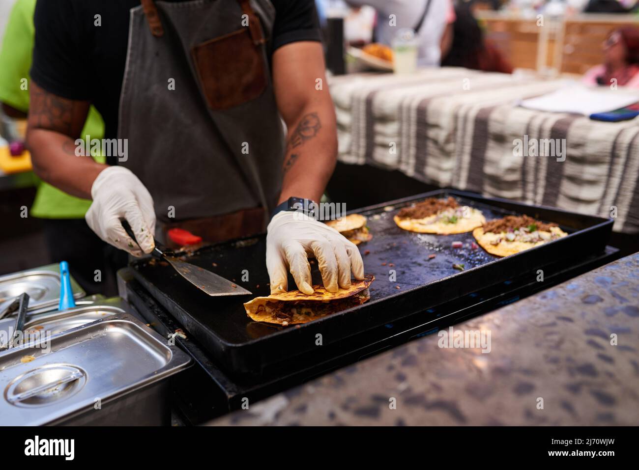 A chef folds over a taco at a busy food market Stock Photo - Alamy
