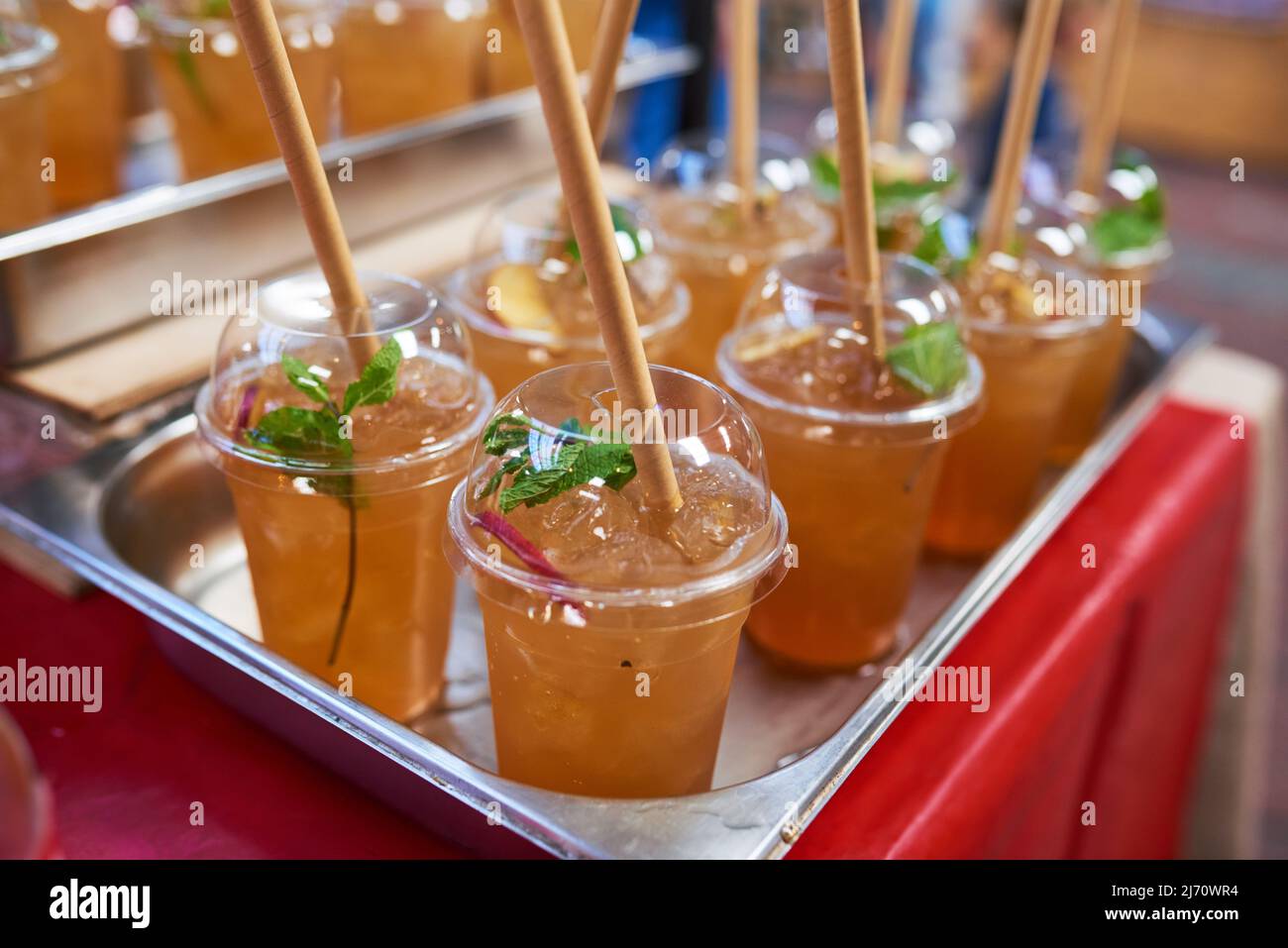 Iced tea on sale at a market with cardboard straws Stock Photo - Alamy