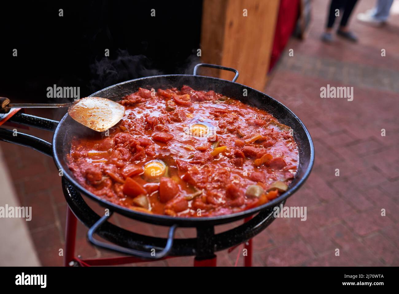 A giant pan of shakshuka being cooked at a market outdoors Stock Photo ...