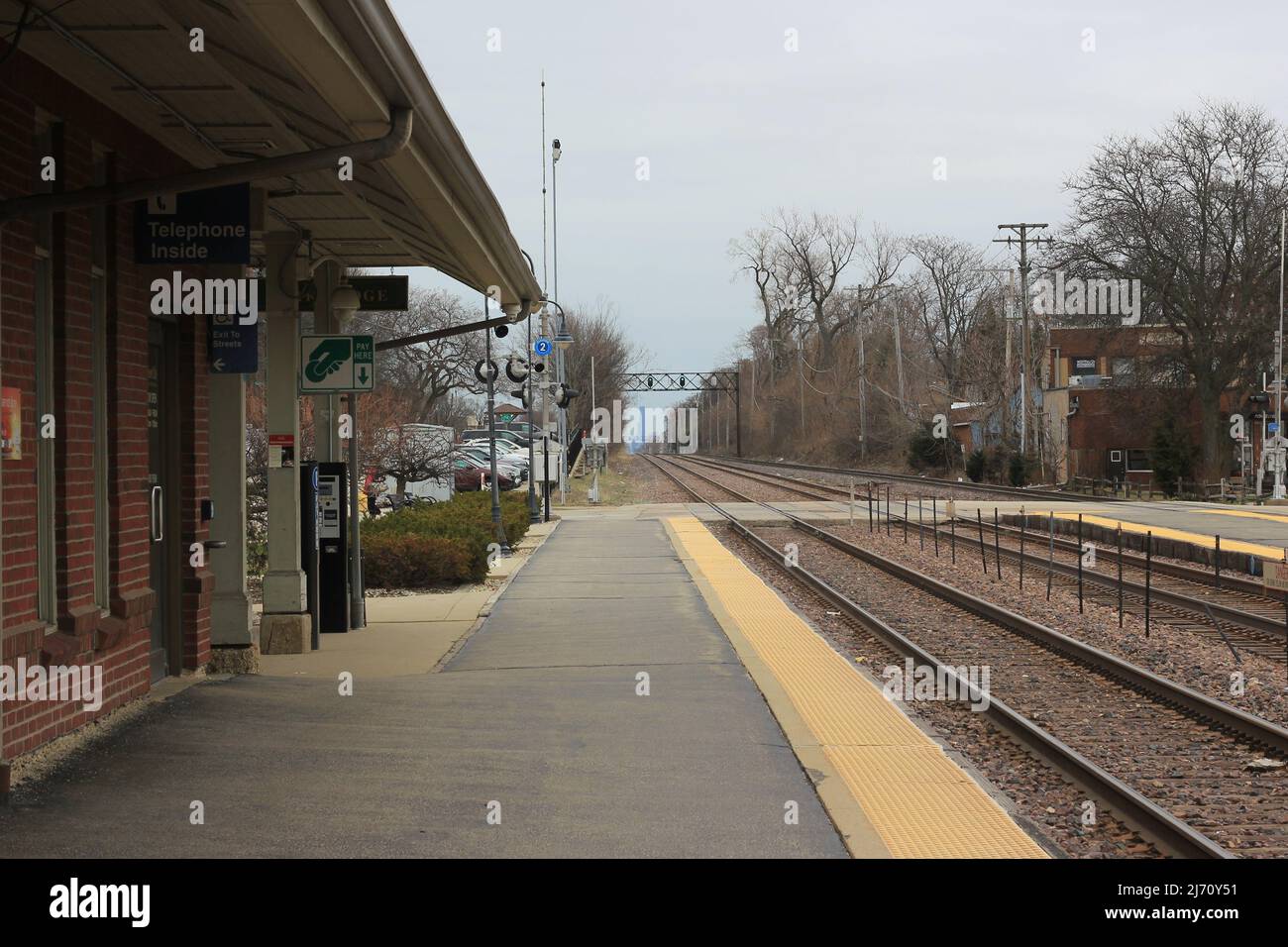 Small town train station platform with typical train tracks Stock Photo ...
