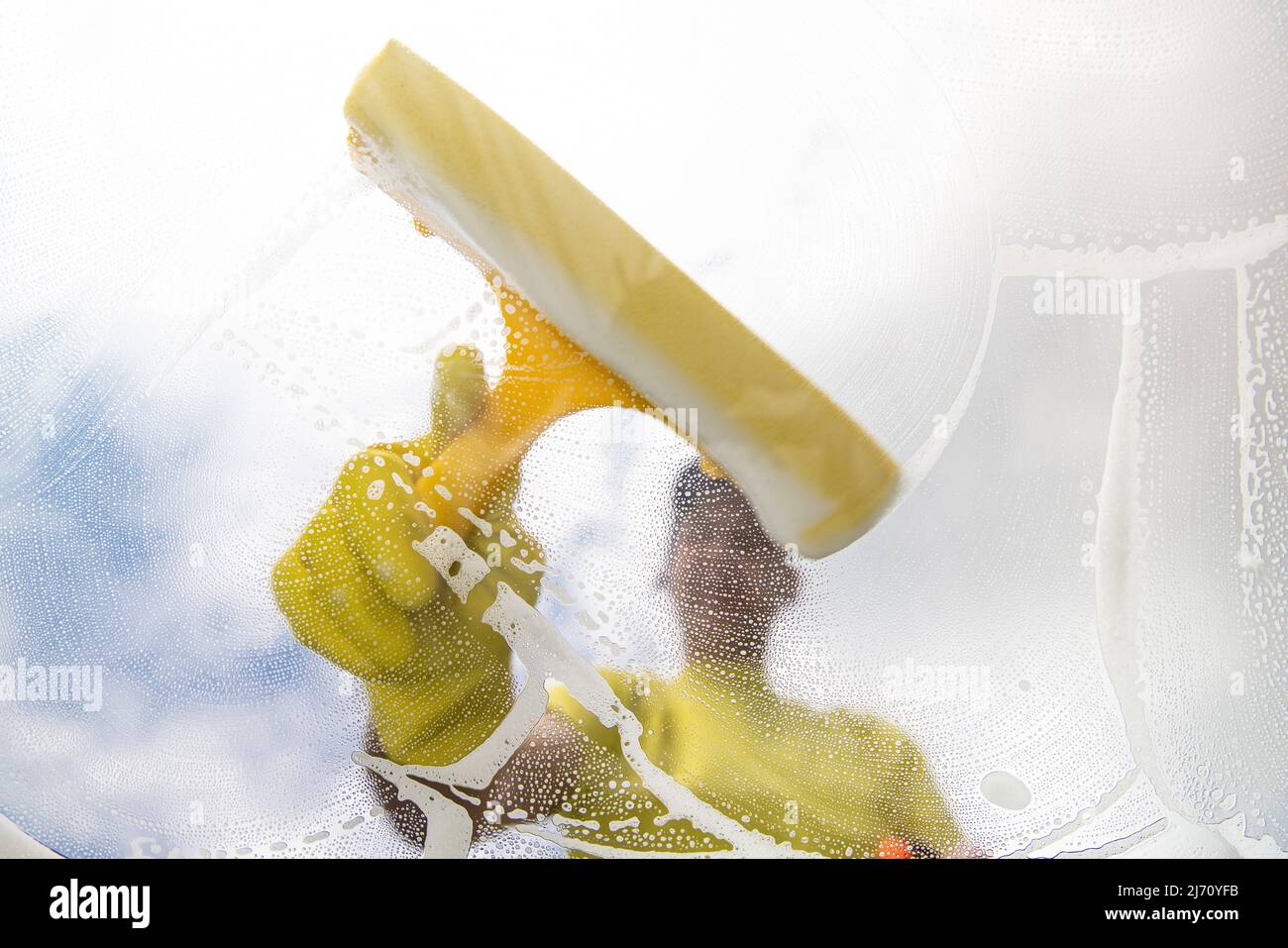window cleaner cleaning window with squeegee and wipe Stock Photo - Alamy