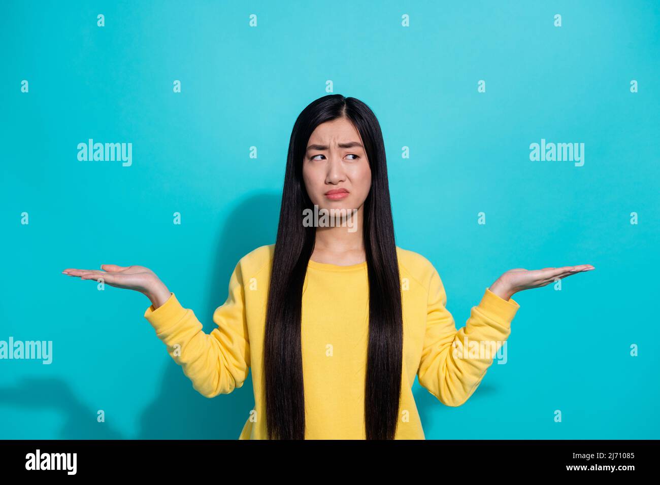 Photo of doubtful unsure lady dressed yellow sweater comparing arms ...