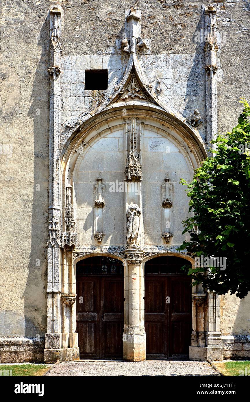 Ornate stone portal and door of a medieval church in Champagne, France ...