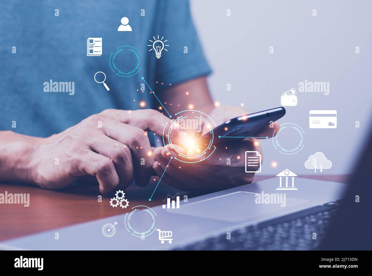 Man using laptop and smartphone with IOT, internet of things badge ...