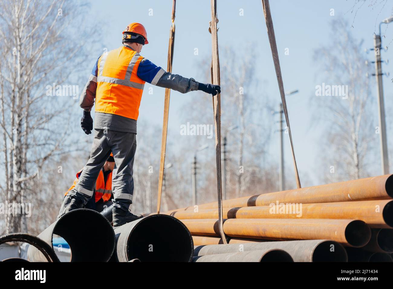 Crane lifting pipes hi-res stock photography and images - Alamy