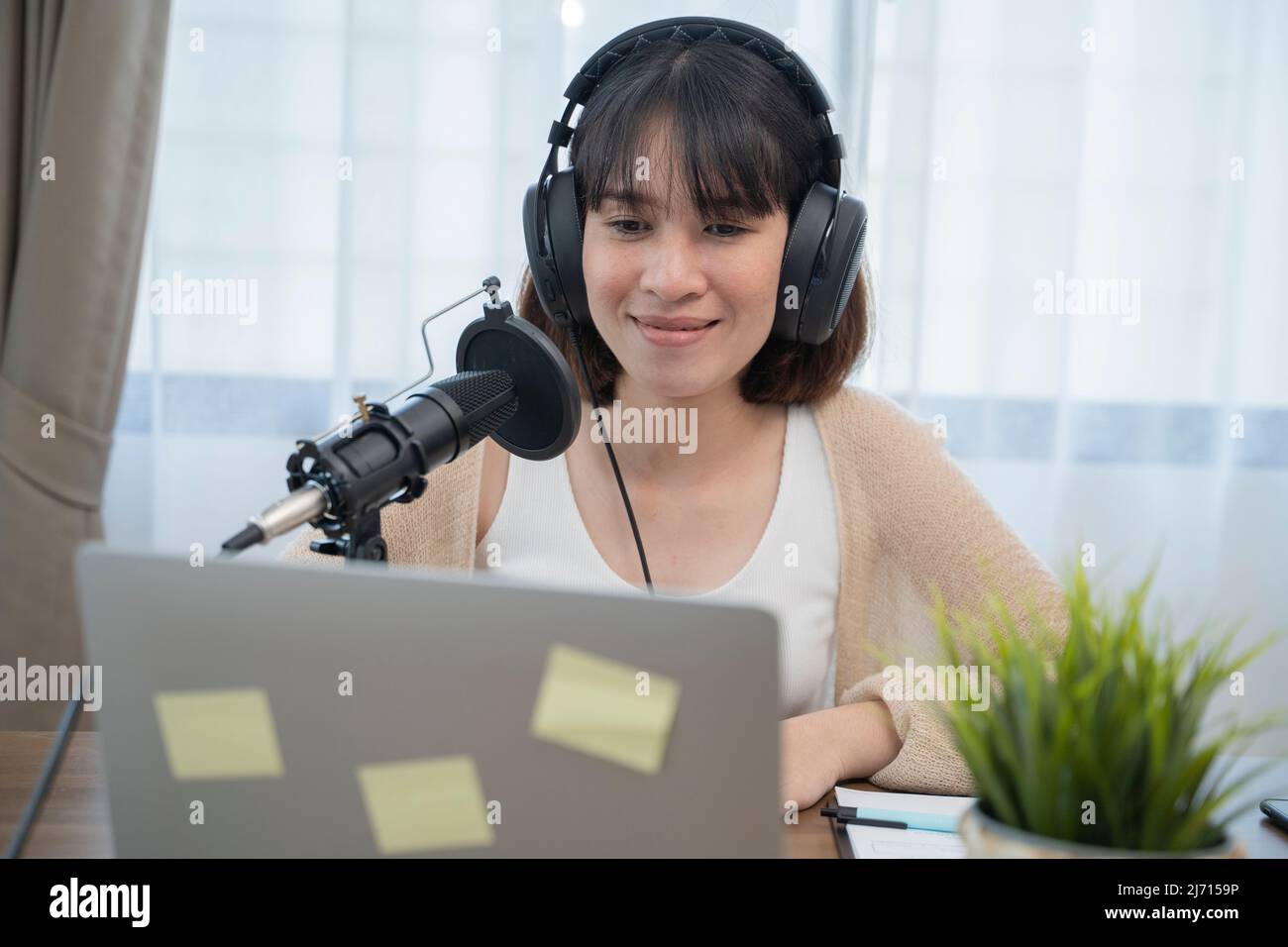 Woman speaking expressively with hand gestures into a microphone at ...