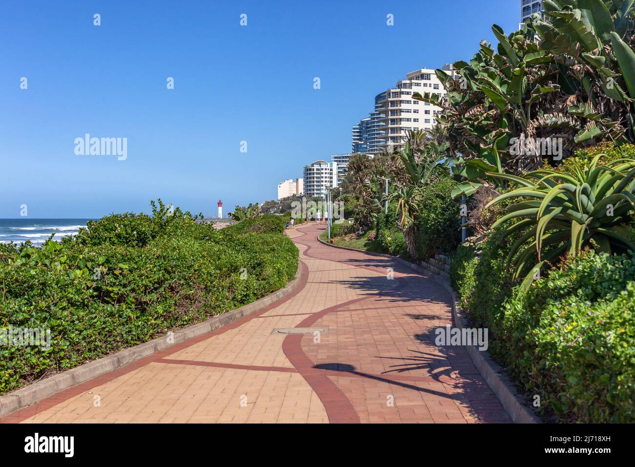 Public walking pathway along beach ocean sea landscape with apartment ...