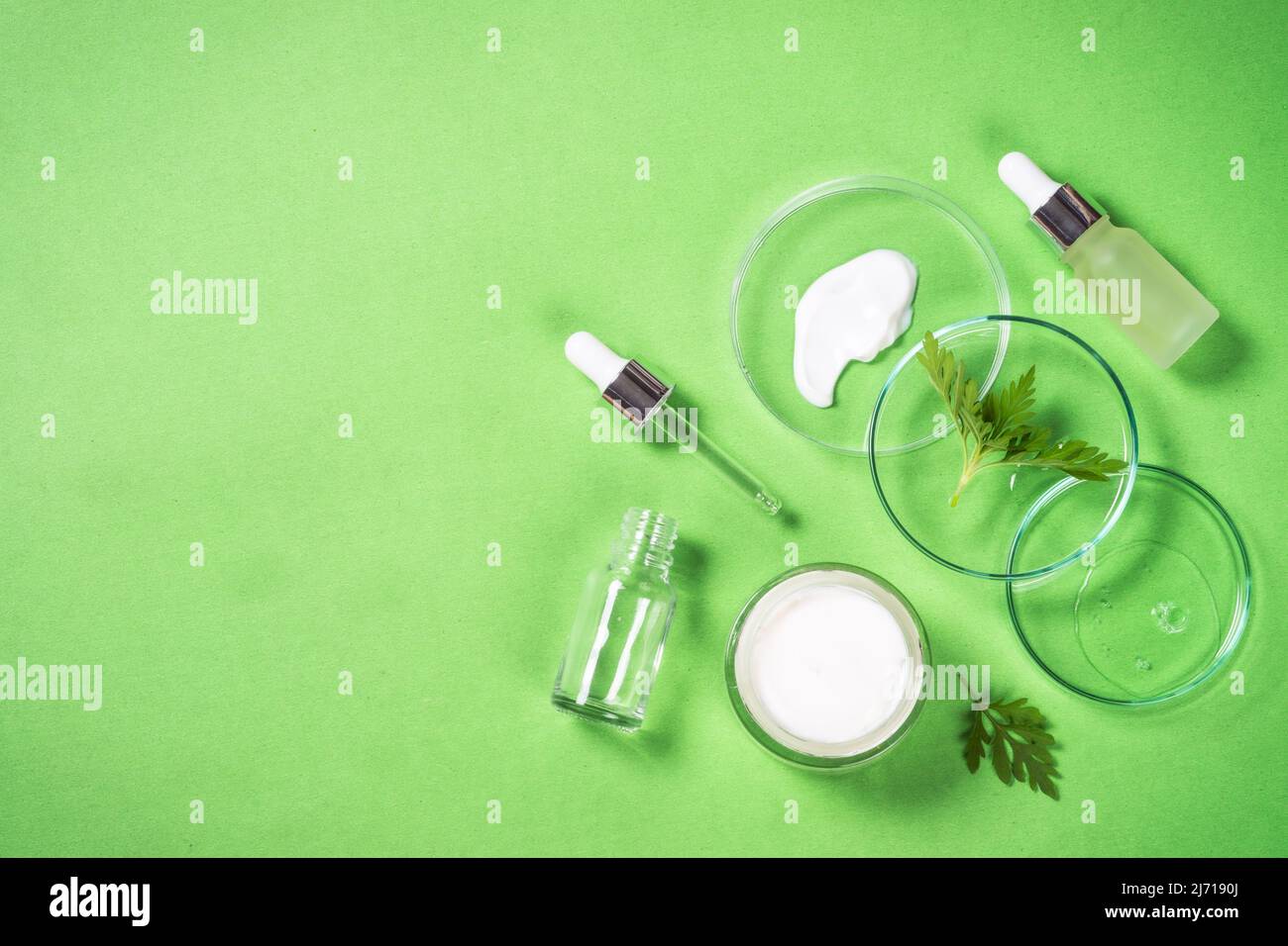 Cosmetic laboratory concept at green background top view Stock Photo ...