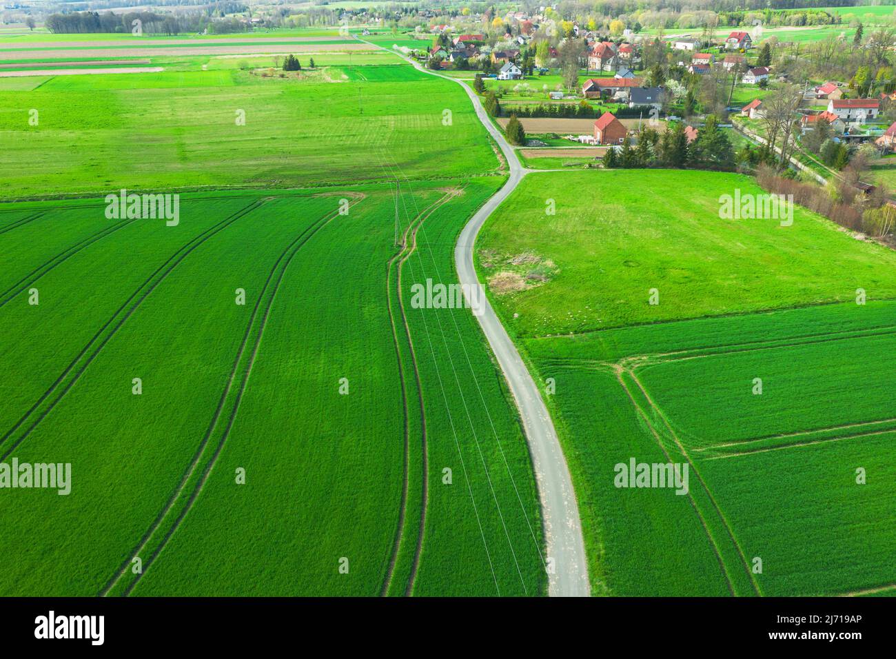 A dirt road running through fields and meadows seen from above. Photo ...