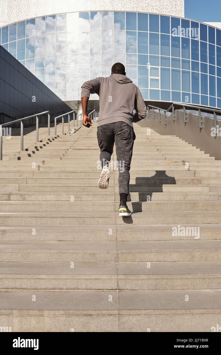 Black man running up stairs hi-res stock photography and images - Alamy