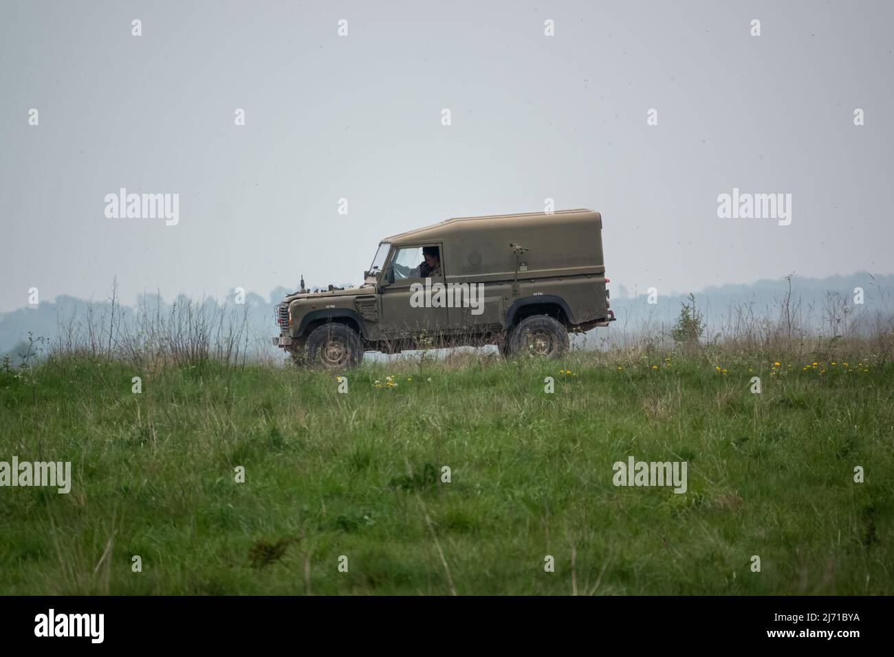 British army Land Rover Defender Wolf medium utility vehicle driving ...