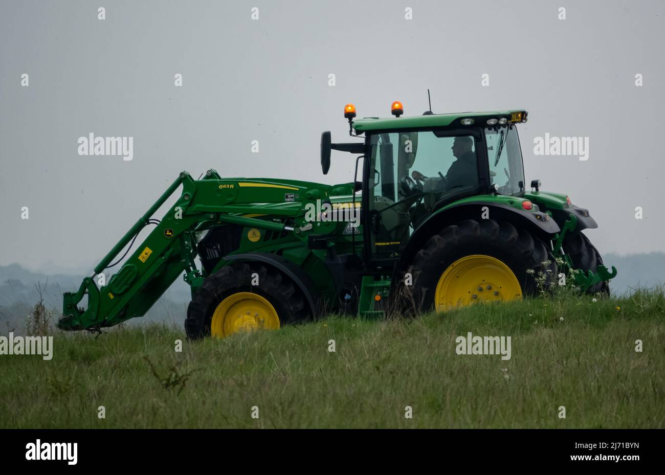 John Deere 6215R farm tractor in motion with front lifter Stock Photo ...