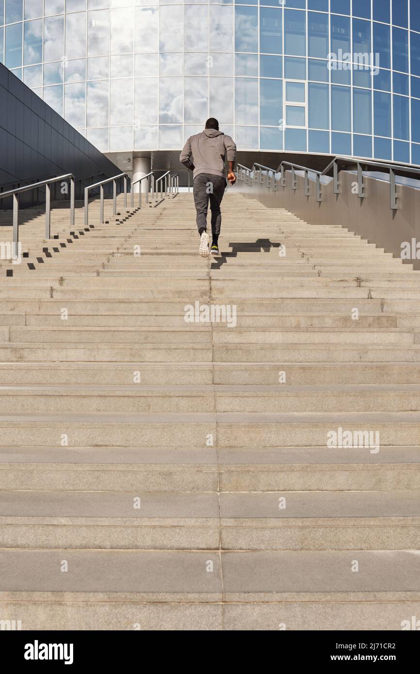 Black man running up stairs hi-res stock photography and images - Alamy